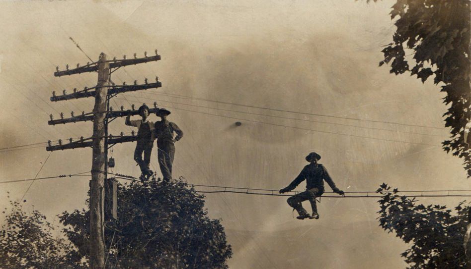 Stunning Photos of Linemen Working on Wooden Utility Poles from the ...