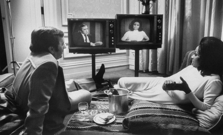 Flickering Memories: A Journey Through Vintage Photos of People Watching TV